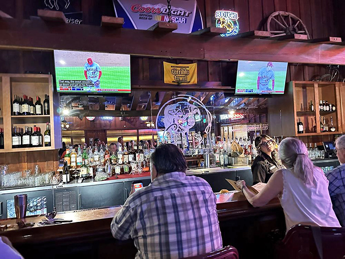 The bar—where decisions between bourbon and beer are contemplated while sports play silently overhead. A sanctuary of spirits and camaraderie.