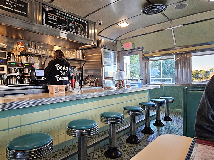 The counter seating offers front-row tickets to the breakfast show. Turquoise stools await as kitchen wizards transform simple ingredients into diner magic.