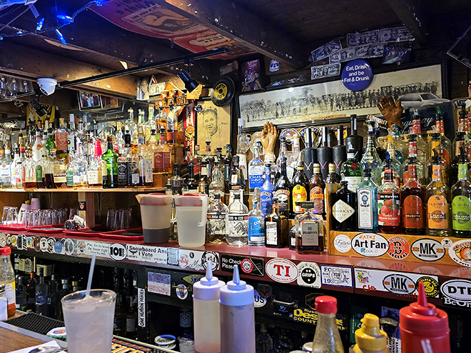 Behind the bar, bottles and signs create a backdrop worthy of any classic American tavern.