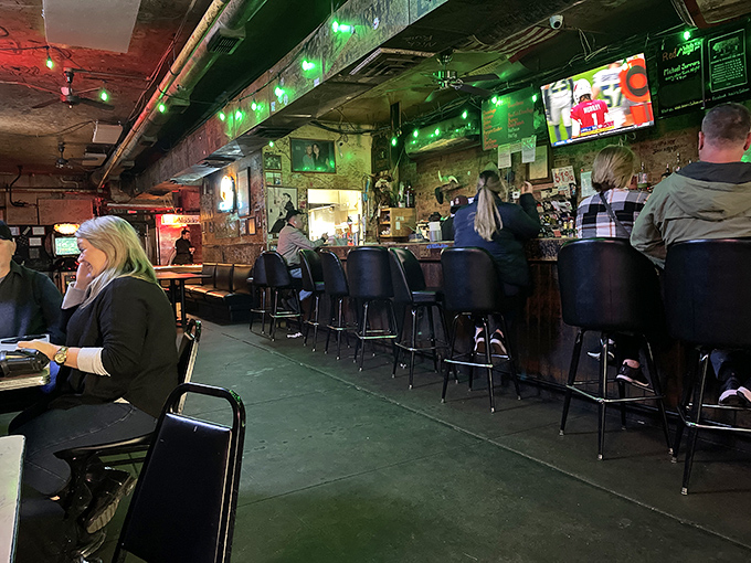 The bar at Adair's&mdash;where strangers become friends, and friends become regulars. The green lights aren't just ambiance; they're permission to stay awhile.