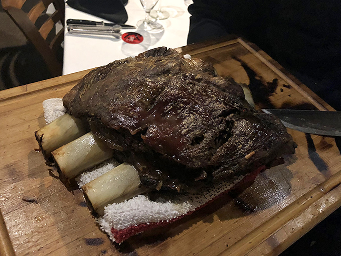 These short ribs aren't just dinner; they're a primal experience served on bone handles. Fred Flintstone would approve enthusiastically.