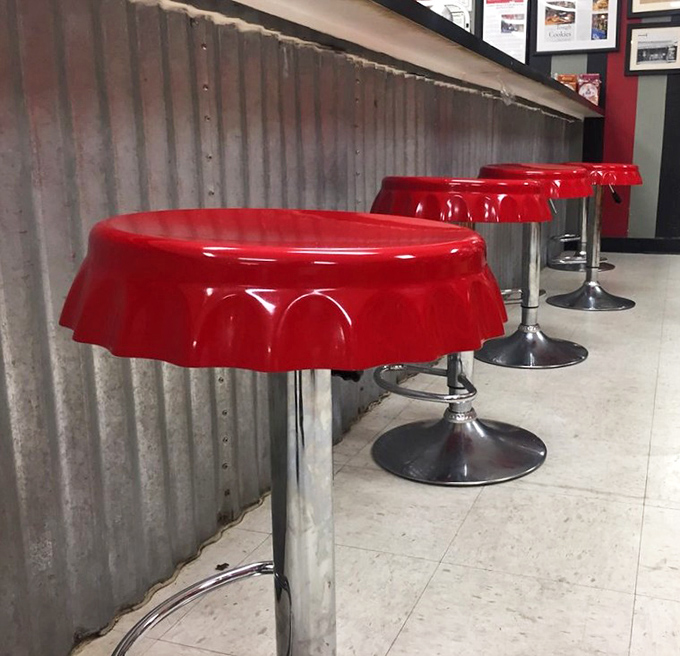 Bottle cap-shaped stools at the counter&mdash;where sitting down is the first step in a journey of delicious decisions.