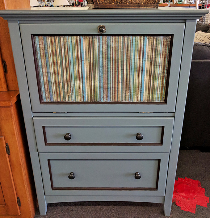 This charming blue dresser with striped fabric insert shows how previous owners' DIY projects can become your ready-made statement piece.