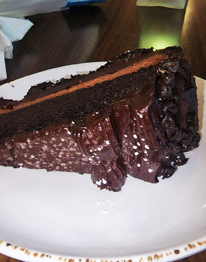 Chocolate cake so rich it probably owns beachfront property. The kind of dessert that makes you close your eyes when you take a bite.