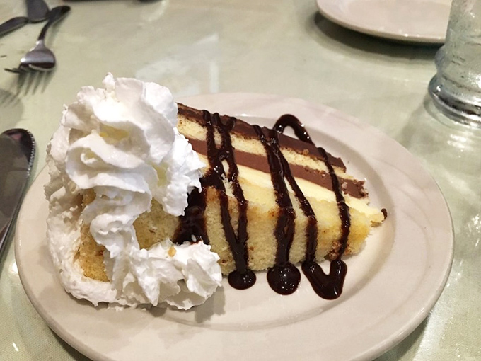 A slice of cake that transports you straight to grandma's kitchen, complete with whipped cream cloud and chocolate drizzle. Diet plans surrender immediately.