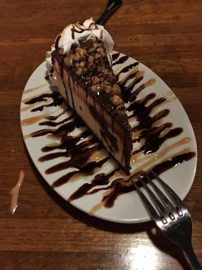 This isn't just cheesecake; it's architecture with calories. The chocolate and caramel drizzles aren't decoration&mdash;they're essential infrastructure.