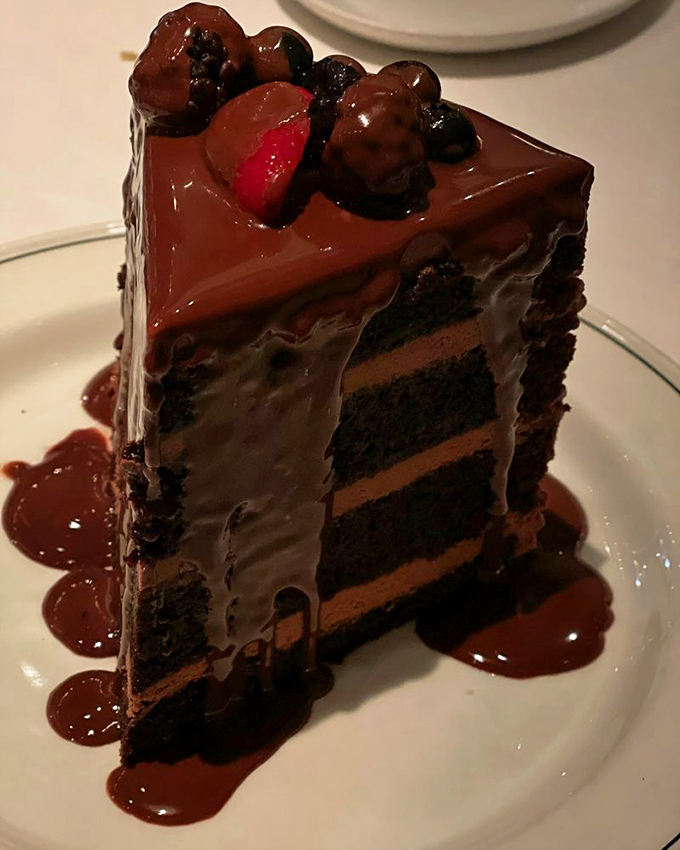 This chocolate cake doesn't just have layers—it has chapters, each one telling a richer story than the last. The berries on top? The happy ending.
