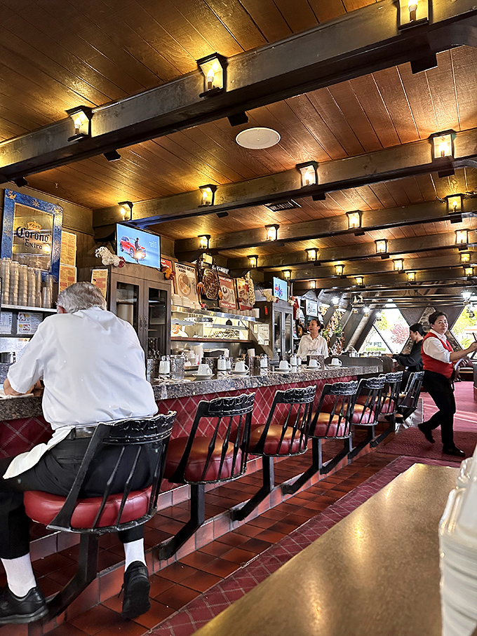 The counter&mdash;where breakfast magic happens. Those red stools have witnessed countless coffee refills and "just one more pancake" negotiations over the years. 
