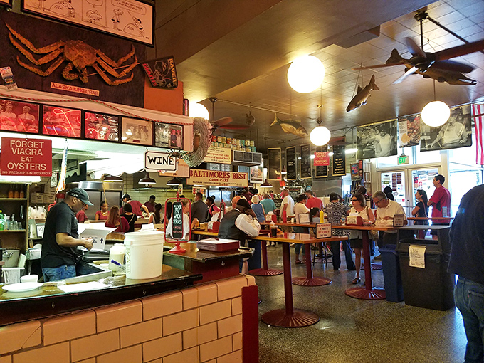 A bustling crowd gathered around standing tables, united in the pursuit of seafood excellence. This isn't dining&mdash;it's a Baltimore tradition performed daily.