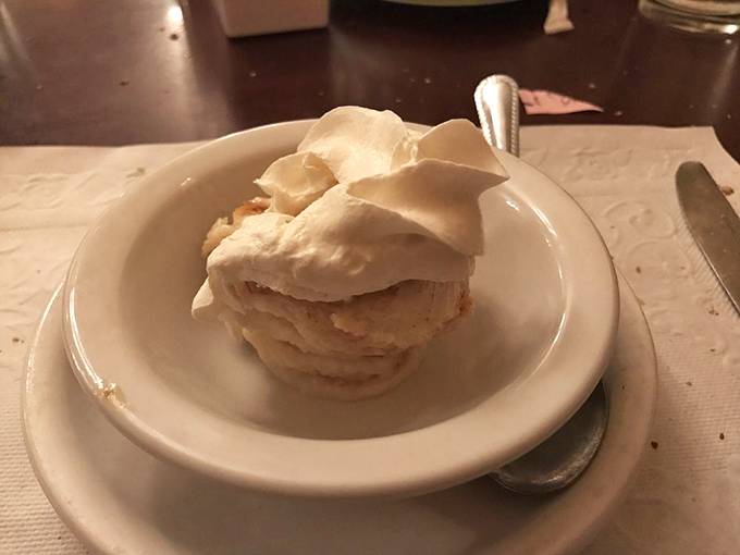 Ice cream nestled in its own cloud of whipped cream. The perfect sweet finale that somehow leaves room for "just one more bite."