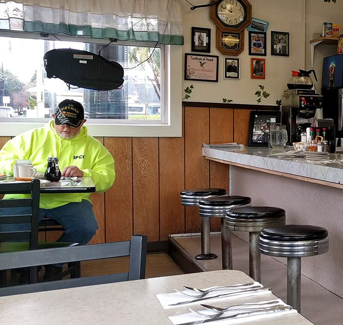 A regular enjoying his morning ritual&mdash;proof that the best dining companions are sometimes a good cup of coffee and a hearty breakfast.