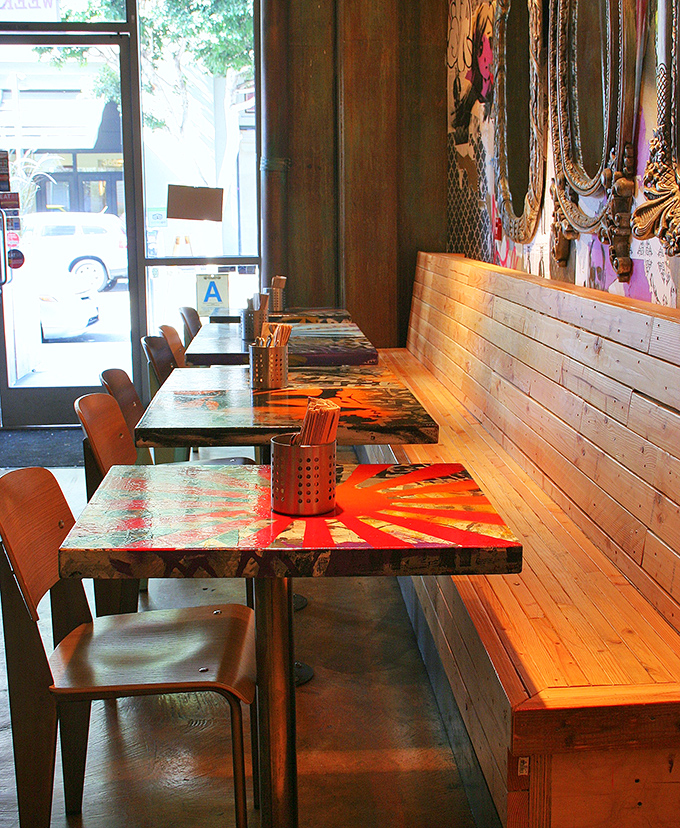 Colorful tables line wooden benches in perfect harmony, like the flavors in your d&ouml;ner wrap waiting to be discovered.