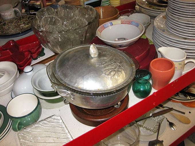 Kitchen essentials arranged with chaotic charm. That silver chafing dish has probably served everything from 1970s fondue to last decade's potluck casseroles.