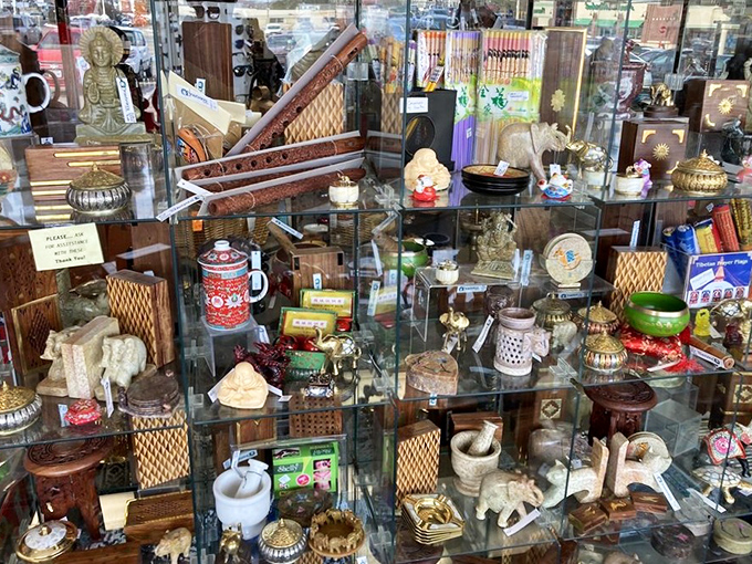 This glass case of international curiosities proves that someone's "What was I thinking?" vacation purchase becomes another person's perfect mantel treasure.