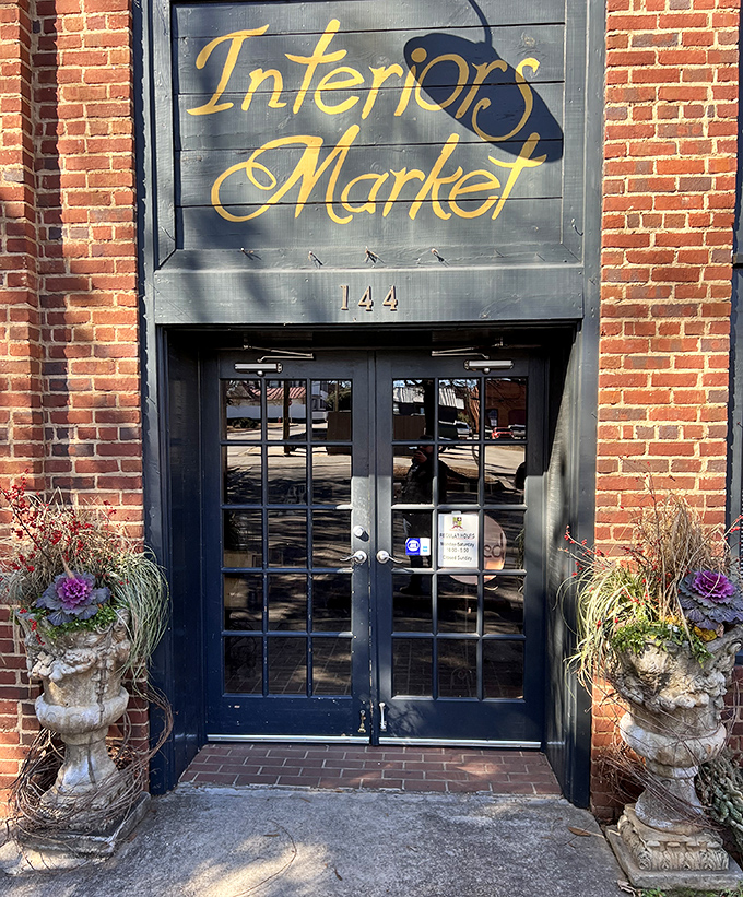 The entrance to Interiors Market stands like a portal to possibility, flanked by stone planters that have weathered more seasons than we can count.