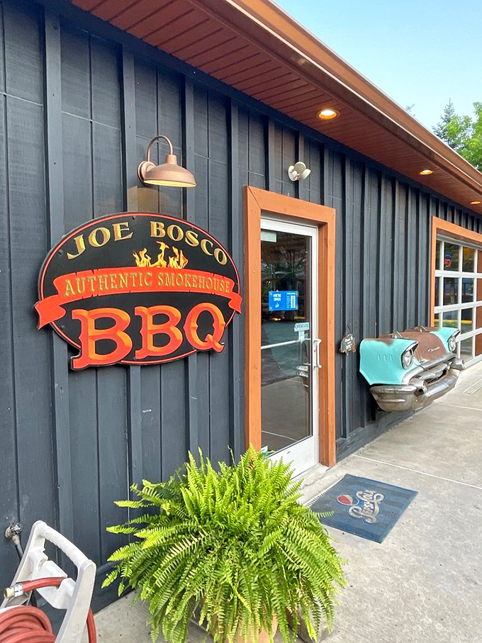 The entrance says it all&mdash;authentic smokehouse BBQ with vintage car flair. That fern isn't just decoration; it's trying to absorb BBQ knowledge.