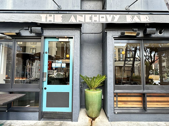 The distinctive turquoise door serves as a portal to seafood nirvana. That simple exterior hides culinary treasures within&mdash;like finding a pearl in an unassuming oyster.