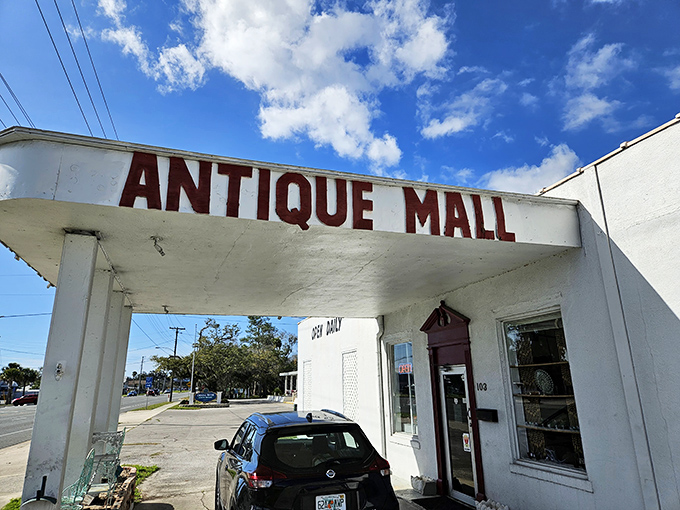 The entrance beckons with promises of discoveries within. That "ANTIQUE MALL" sign has guided countless treasure hunters to their happy place.