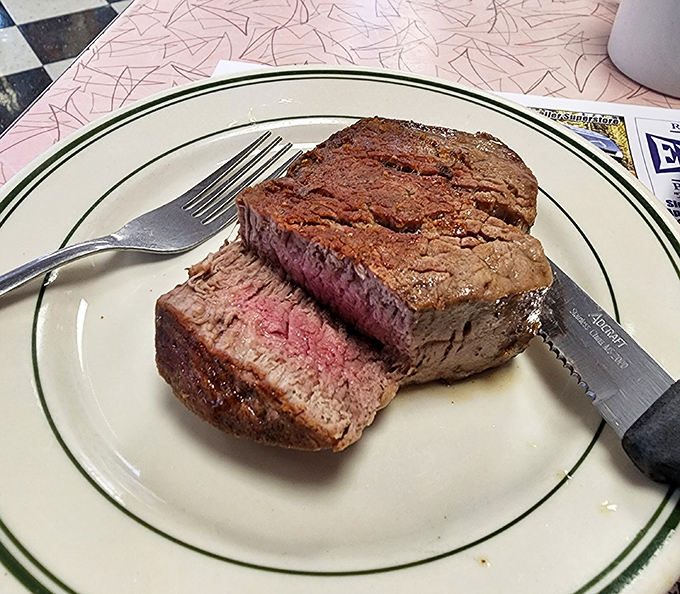 A perfectly cooked filet mignon that proves fancy steakhouses don't have a monopoly on proper beef. That pink center whispers, "Someone in this kitchen knows what they're doing."