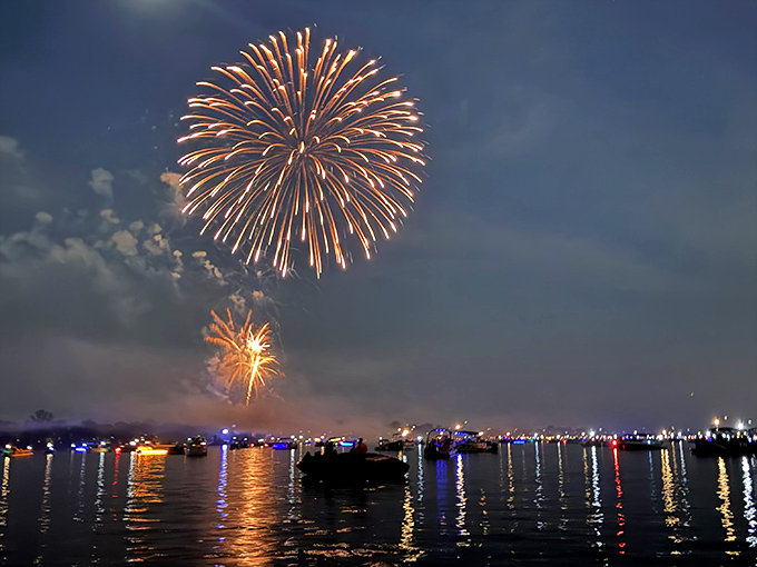 Nature's fireworks display meets human ingenuity. The lake transforms into a mirror, doubling the spectacle for twice the oohs and aahs.