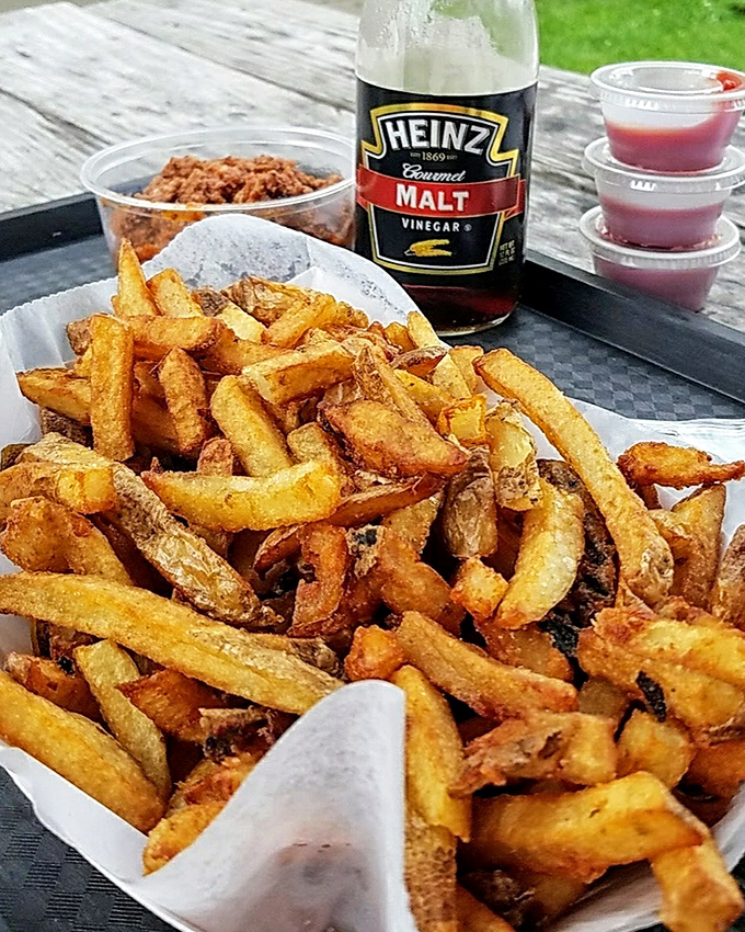 Fries so perfectly golden they deserve their own Instagram account. That bottle of malt vinegar standing by is no accident&mdash;it's tradition waiting to happen.