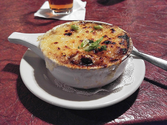 French onion soup with a cheese cap so perfectly browned, it deserves its own moment of silence before you break through to the treasure below.