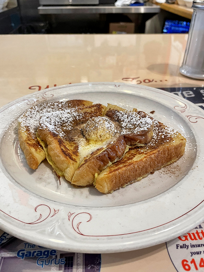 French toast that makes you wonder if your grandmother has been moonlighting in the kitchen&mdash;golden, crisp, and dusted with powdered nostalgia.