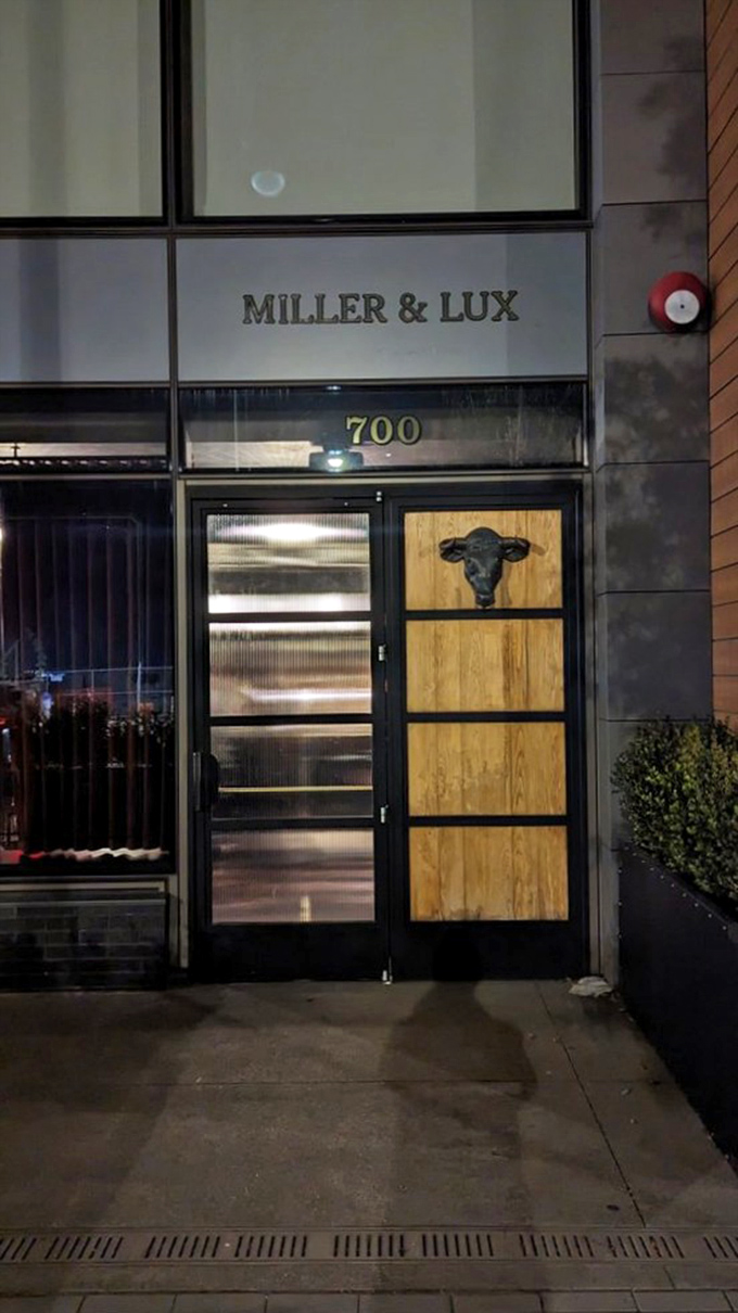 The entrance at night transforms into a beacon for hungry souls. That bull silhouette isn't just decoration—it's a promise of bovine excellence within.