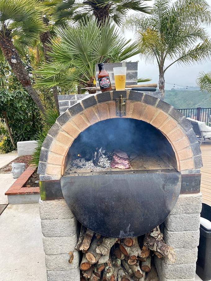 Smoke, fire, and patience&mdash;the eternal elements of great barbecue. This outdoor cooking setup shows barbecue in its most primal form.