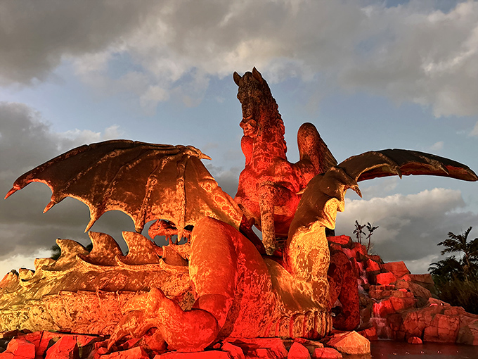 Fire and ice vibes as night falls. The dramatic lighting transforms bronze into something otherworldly&mdash;part sculpture, part light show.