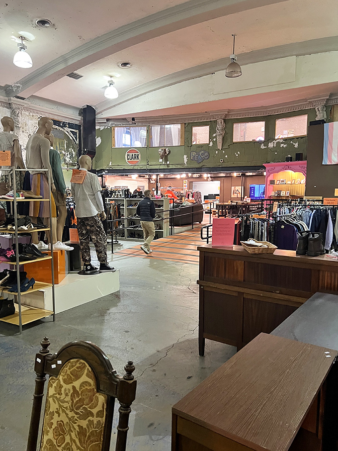 Mannequins model possibilities while shoppers browse. The theater's original architectural details create shopping "rooms" that make treasure hunting feel less overwhelming and more intentional.