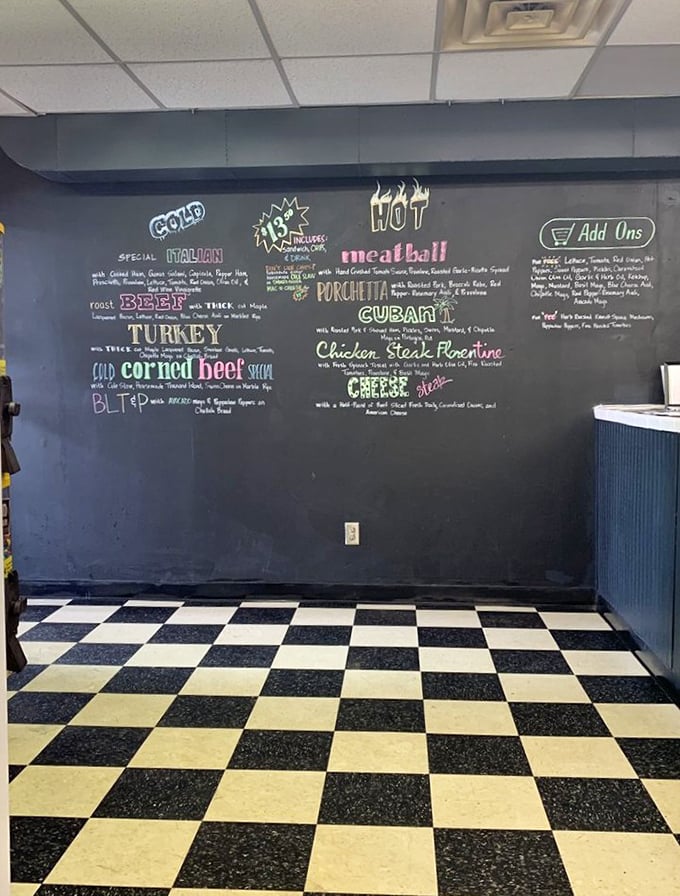 The chalkboard menu wall &ndash; where sandwich dreams are written before becoming delicious reality. That floor is pure old-school deli perfection.