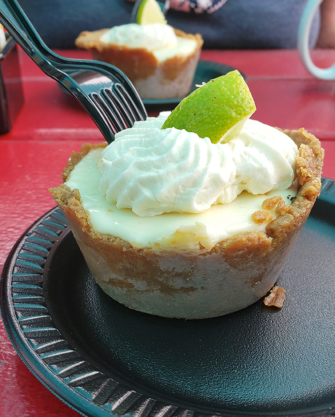 This key lime pie isn't messing around &ndash; the perfect balance of sweet and tart, topped with a dollop of whipped cream and a lime garnish for good measure.