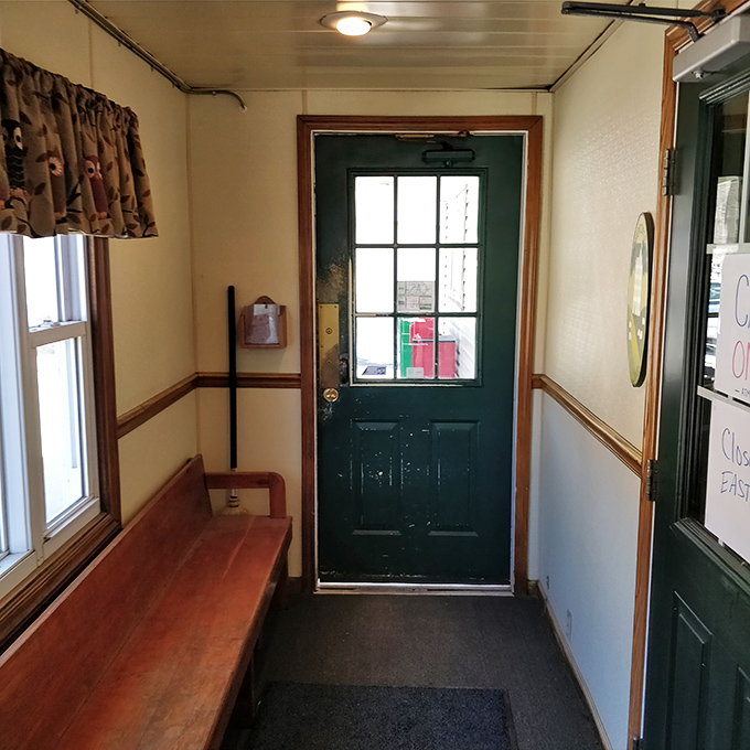 The welcoming entrance that leads to breakfast bliss, complete with comfortable seating for those inevitable wait times.