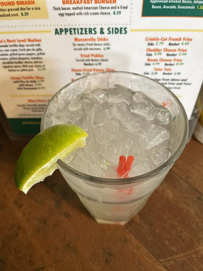 A proper lime wedge perched on the edge of a frosty glass&mdash;the sign of a drink mixed with care and attention to detail.