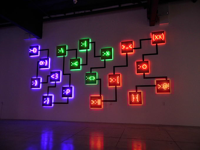 These neon emoticons communicate in the universal language of light, expressing digital feelings through the very analog medium of bent glass.