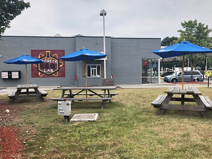 Outdoor seating for those who can't wait to dig in. Blue umbrellas provide shade while you contemplate the meaning of barbecue perfection.