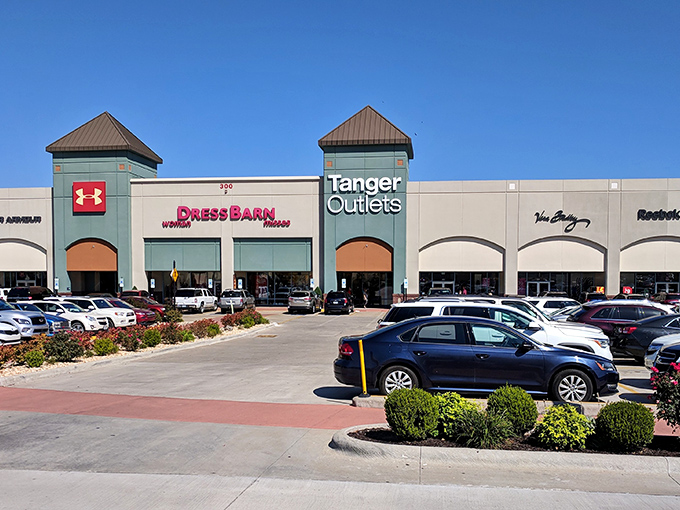 Architectural retail harmony under Ozark blue skies. Those aren't just stores—they're chapels in the cathedral of commerce.