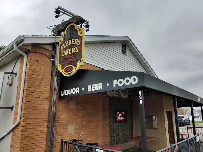 The vintage sign hanging proudly, announcing "LIQUOR &bull; BEER &bull; FOOD"&mdash;three simple words that sum up everything wonderful about the American tavern experience.