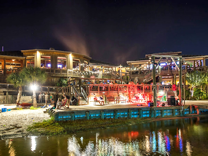 When the sun goes down, Boshamps lights up the harbor. This nighttime view shows why evening reservations are worth their weight in grouper.