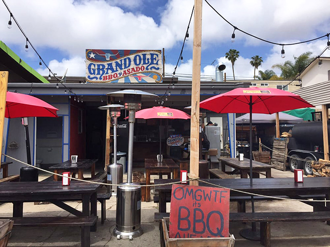 "OMGWTF it's BBQ" says it all. Red umbrellas, picnic tables, and the promise of smoky treasures under the San Diego sun.