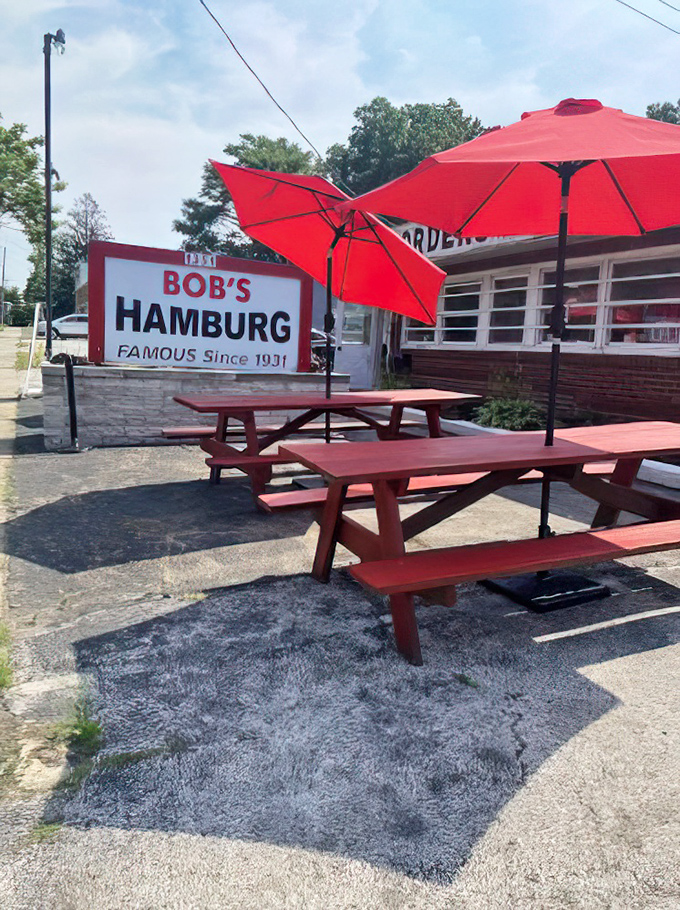 Those red picnic tables under bright umbrellas aren't just outdoor seating&mdash;they're community gathering spots where summer memories are made between bites of perfect burgers.