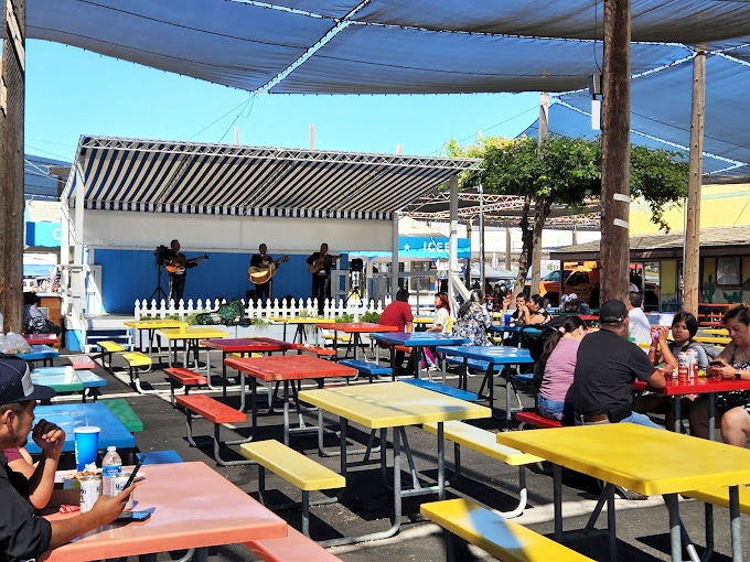 Fiesta-worthy dining! These rainbow-colored picnic tables invite you to rest weary shopping feet while mariachi melodies enhance your meal.