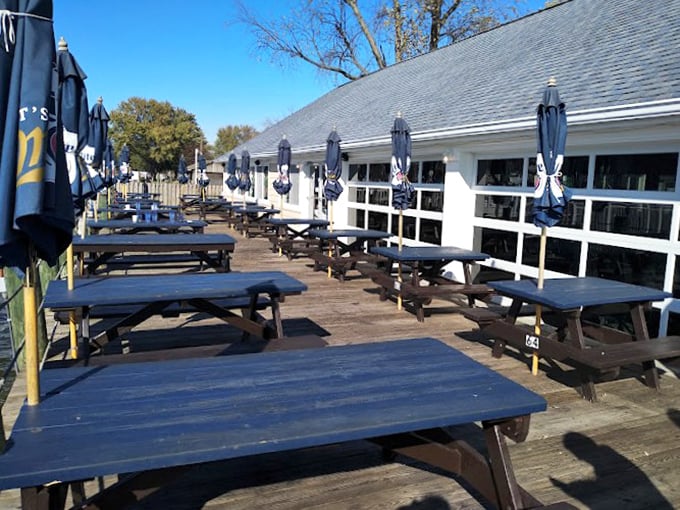 Those navy blue picnic tables aren't just outdoor seating&mdash;they're front-row seats to the daily spectacle of Chesapeake Bay life. Umbrellas optional, good times guaranteed.