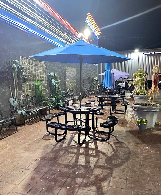 The outdoor dining area offers a quieter alternative for enjoying your feast under the stars, with neon lights creating a magical midnight glow.