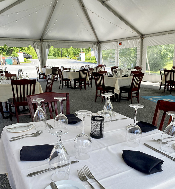 Outdoor dining under crisp white tents&mdash;where summer evenings stretch longer and wine somehow tastes better in the fresh air.