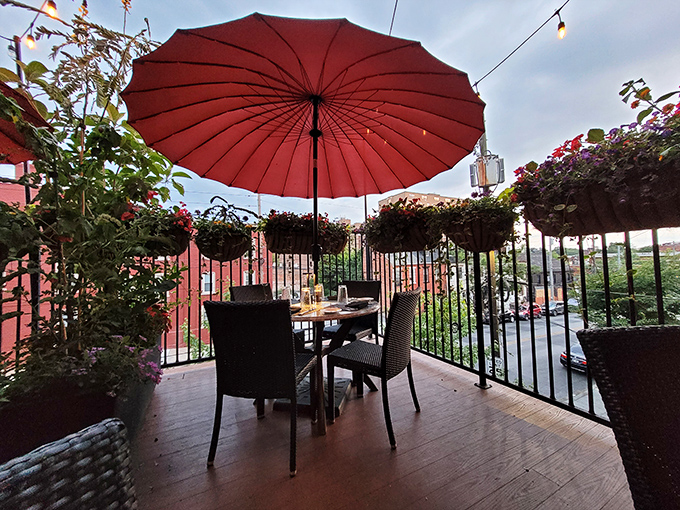 The outdoor dining area offers a secret garden escape. That red umbrella isn't just shade&mdash;it's a signal that something special happens here.