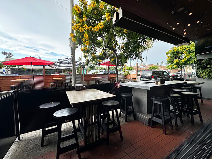 The outdoor patio – where San Diego's perfect weather meets perfect pizza, under the gentle shade of flowering trees.