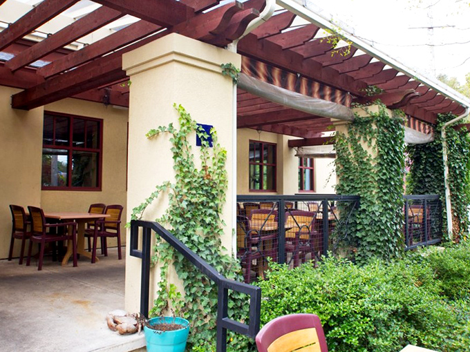 The ivy-draped patio offers a serene outdoor dining experience where nature provides the ambiance and Kelly's provides everything else worth caring about.