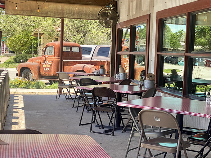Outdoor seating with a view of a vintage truck&mdash;because good barbecue deserves good scenery and fresh Hill Country air.